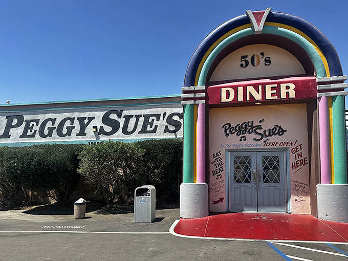 The jukebox-shaped entrance to Peggy Sue's stands like a technicolor mirage in the desert, promising relief for weary travelers and hungry road-trippers alike.