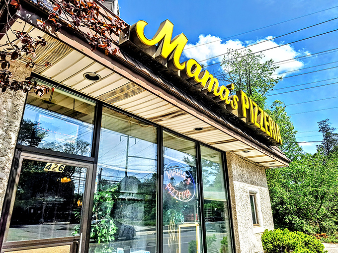 The iconic yellow Mama's Pizzeria sign beckons hungry travelers like a cheesesteak lighthouse on Belmont Avenue. No fancy frills, just the promise of sandwich perfection.