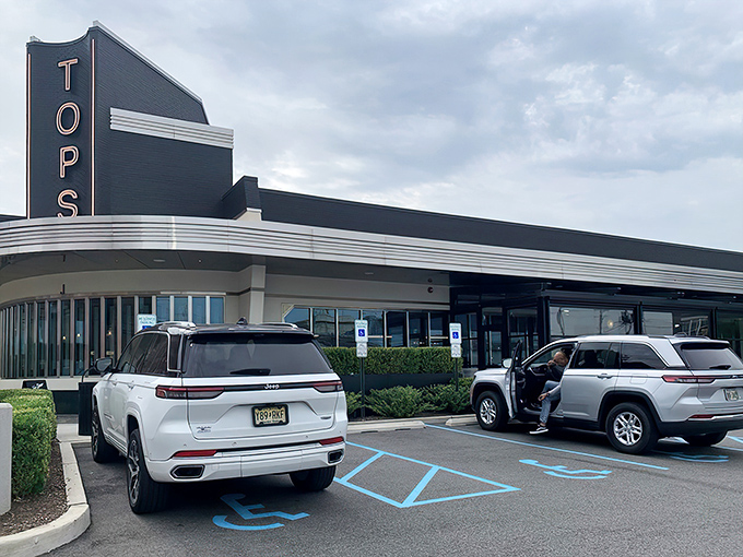 The gleaming art deco fa&ccedil;ade of Tops Diner stands like a beacon of culinary promise against the New Jersey sky, its retro-modern design practically whispering "come hungry, leave happy."