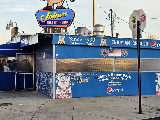That iconic sign promises sandwich salvation. The bright blue building with its cartoon pig mascot is Philadelphia's version of the pearly gates.