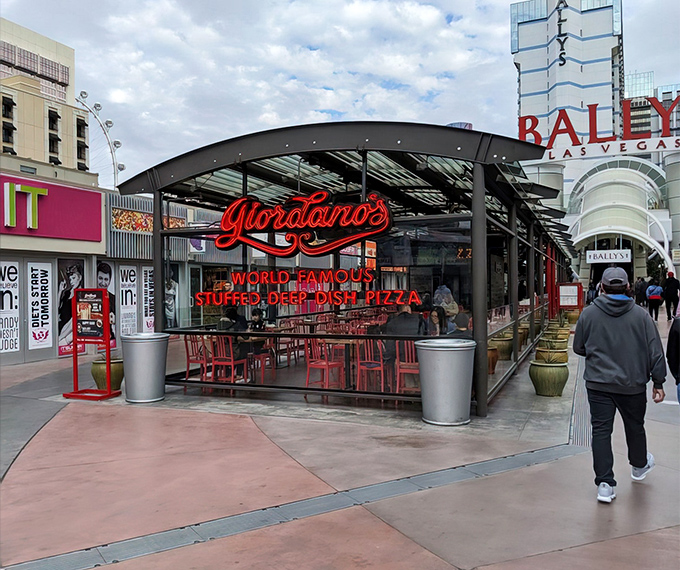 The glowing red Giordano's sign beckons like a pizza lighthouse amid the neon chaos of the Strip. Chicago has landed in Vegas, and it brought its appetite.