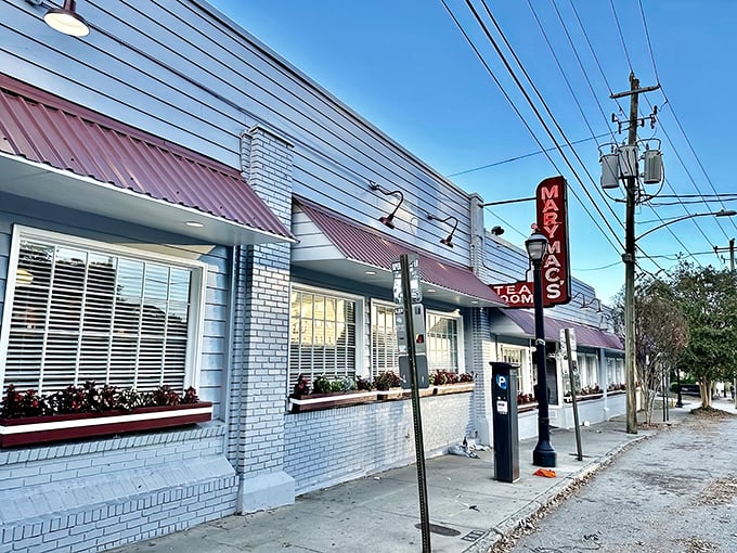 The unassuming brick exterior of Mary Mac's Tea Room stands like a culinary lighthouse on Ponce de Leon Avenue, its burgundy awnings a gentle nod to Southern charm.