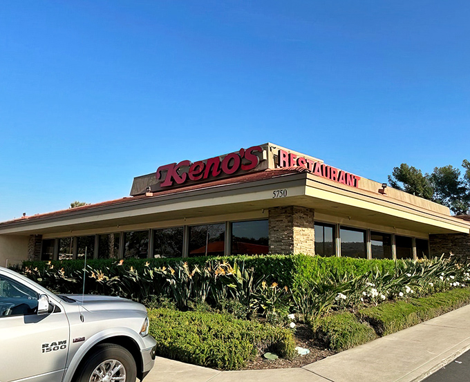 The iconic red signage of Keno's Restaurant stands out against the California blue sky, promising comfort food that's worth the detour from Disneyland.