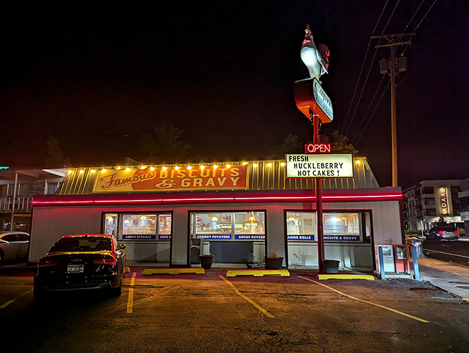 The neon rooster stands sentinel over Fairview Avenue, beckoning hungry travelers with promises of "Famous Biscuits & Gravy" that glow like a comfort food lighthouse.