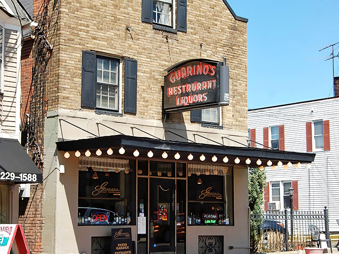 The iconic brick facade of Guarino's stands proudly in Cleveland's Little Italy, its vintage sign a beacon for hungry souls seeking authentic Italian comfort.