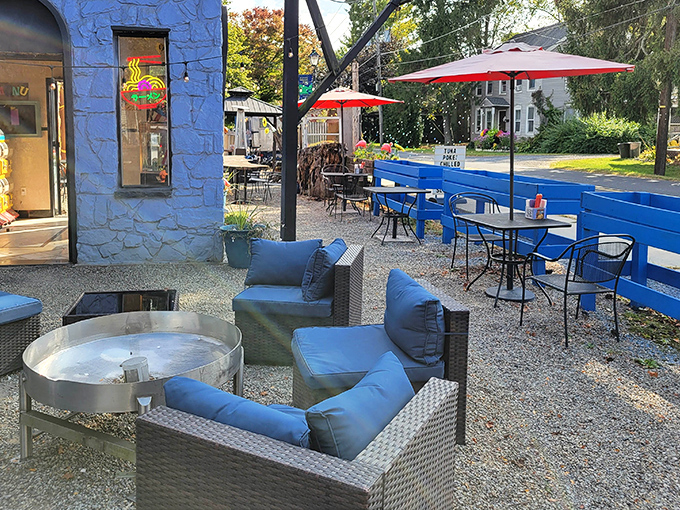 The blue stone exterior isn't just eye-catching—it's a promise of the comfort awaiting inside. Those cozy outdoor fire pits practically beg you to linger over dessert.