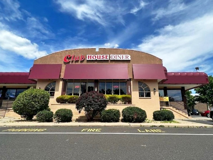 The Club House Diner stands proudly against a blue Pennsylvania sky, its burgundy awnings like a culinary welcome mat inviting hungry travelers to step inside.