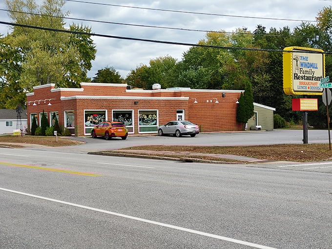 The brick exterior of The Windmill Restaurant stands as a beacon of breakfast hope, complete with its namesake windmill decoration that promises good things are spinning inside.