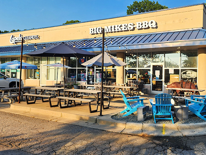 The yellow exterior of Big Mike's BBQ beckons like a barbecue lighthouse, complete with blue Adirondack chairs perfect for post-feast contemplation. 