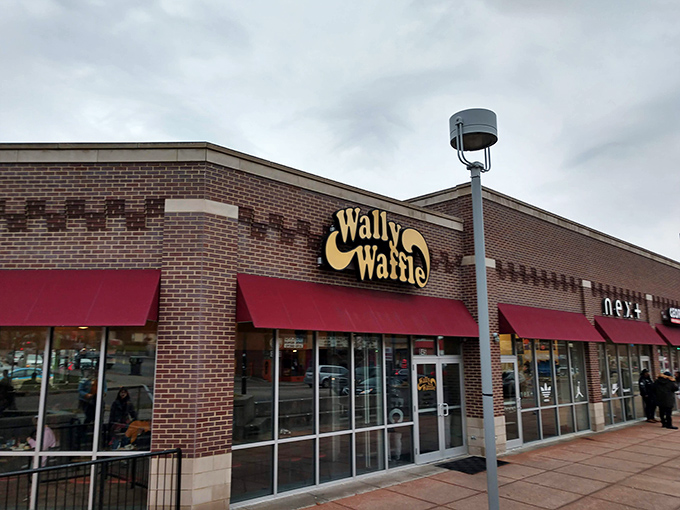 The unassuming brick exterior with its bold red awning promises comfort food magic within. Like finding a secret breakfast society hiding in plain sight.