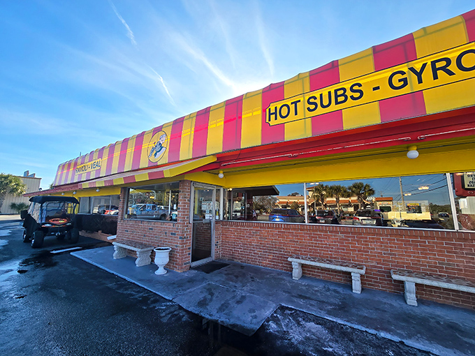 That striped awning isn't just eye-catching&mdash;it's a North Myrtle Beach landmark promising hot subs, gyros, and pizza that'll make your taste buds throw a standing ovation.
