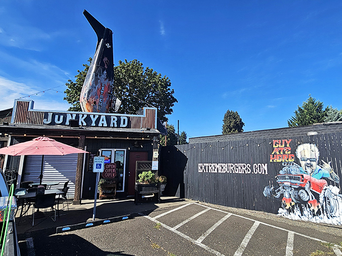 Blue skies frame the ultimate roadside attraction&mdash;where "junkyard" isn't an insult but a promise of automotive-themed deliciousness.