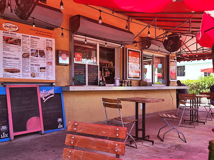 The iconic red awning of Dogma Grill beckons like a culinary lighthouse on Biscayne Boulevard, with its bustling counter promising simple pleasures done right.