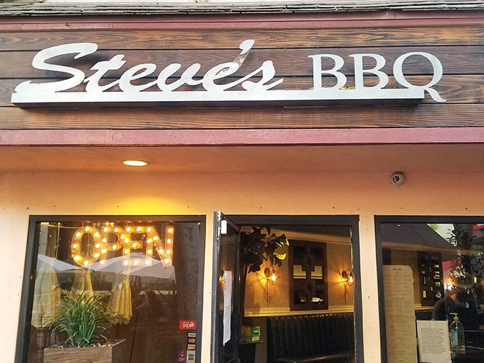 The wooden sign and warm glow of Steve's BBQ beckons like a smoky siren call to hungry Whittier residents. String lights promise good times ahead.