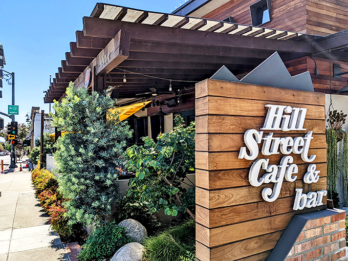 The welcoming wooden facade of Hill Street Cafe & Bar beckons with its stylish signage and lush greenery &ndash; California casual dining at its finest.