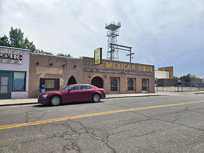 The adobe façade with "MEXICAN FOOD" in bold yellow letters isn't trying to impress anyone—it's too busy perfecting what's inside instead.