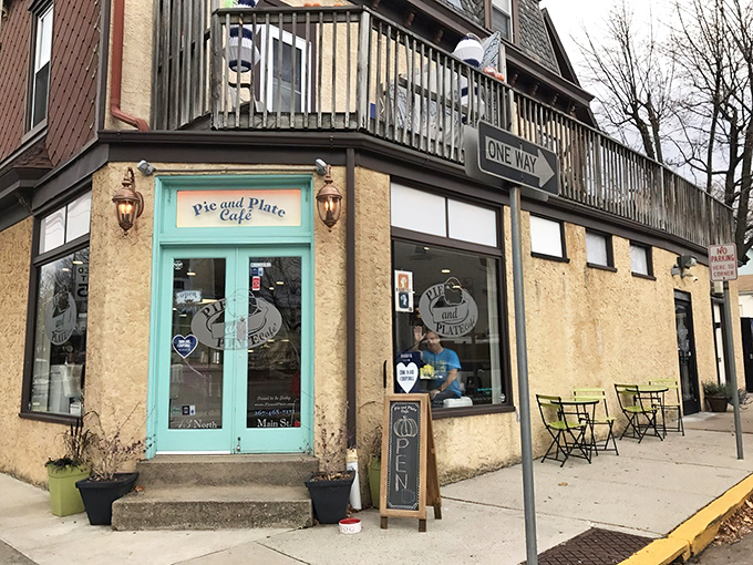 That turquoise door isn't just an entrance&mdash;it's a portal to flaky, buttery happiness disguised as a corner cafe.