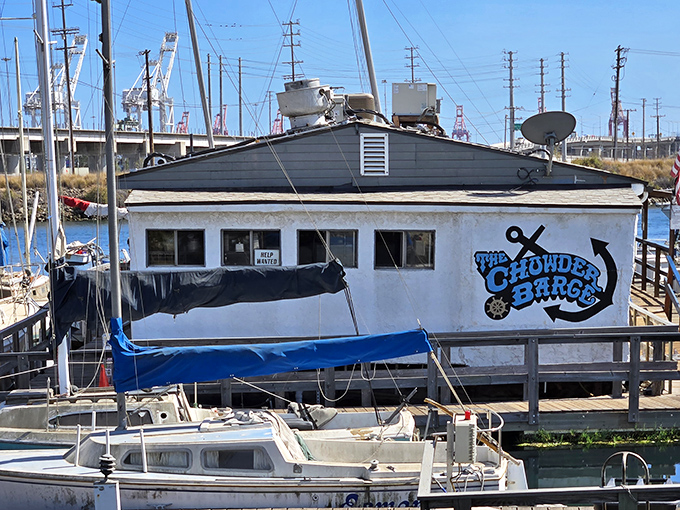The Chowder Barge announces itself with nautical pride, a floating seafood sanctuary amid industrial surroundings that somehow makes perfect sense.