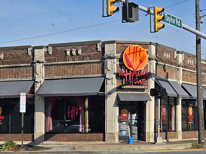 The corner brick building with its bright red logo beckons like a friendly monster under the streetlight. Horror never looked so inviting!