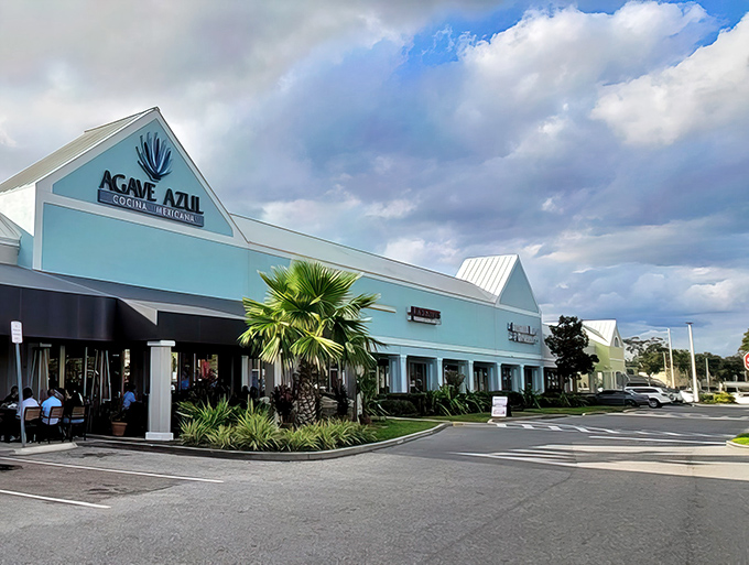 The striking turquoise exterior of Agave Azul stands out like a tropical oasis in the Orlando shopping center landscape, promising authentic Mexican flavors inside.