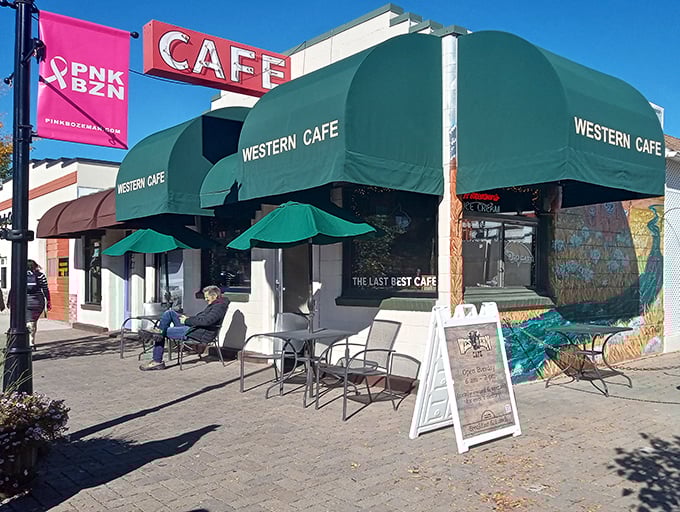 The iconic green awnings and classic neon "CAFE" sign of Western Caf&eacute; stand as a beacon for hungry Bozeman locals seeking authentic Montana comfort food.