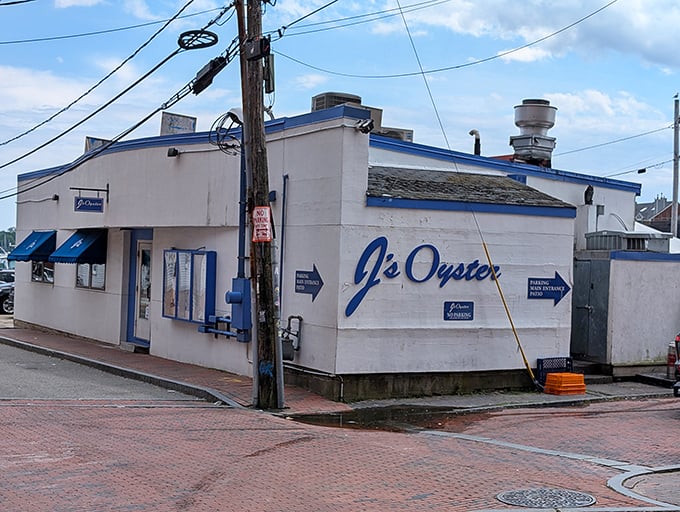 The unassuming white exterior of J's Oyster stands like a culinary lighthouse on Portland's waterfront, beckoning seafood lovers with its iconic blue trim.