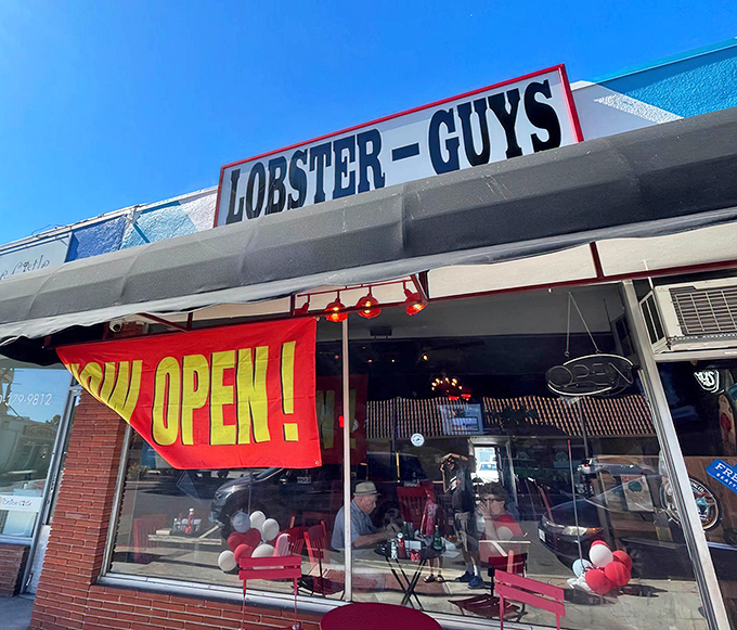 The unassuming storefront of Lobster-Guys beckons with its bold signage and vibrant "NOW OPEN" banner &ndash; proof that culinary treasures often hide in plain sight.