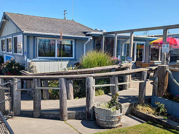 Rustic wooden railings and coastal plantings welcome you to this waterfront gem, where the ocean breeze carries hints of what's cooking inside.