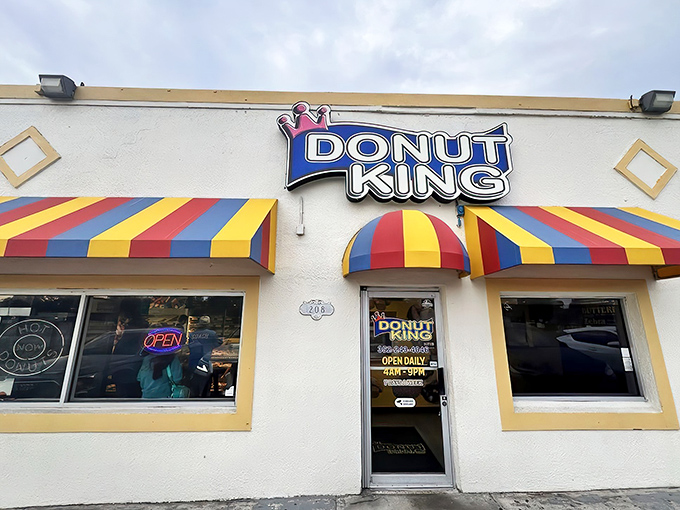 The colorful striped awnings of Donut King beckon like a carnival of sweetness, promising delights that make detours mandatory and diets optional.