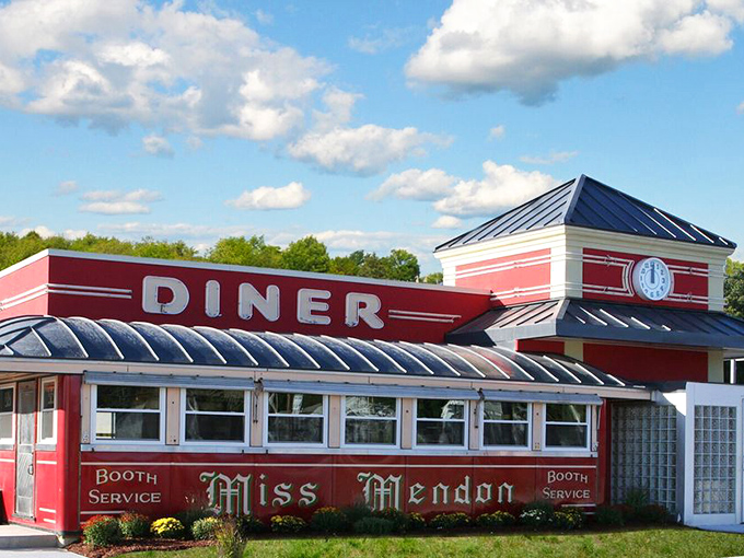 The classic American diner silhouette that promises salvation for empty stomachs. Miss Mendon's vibrant red exterior stands like a beacon of breakfast hope against the Massachusetts sky.