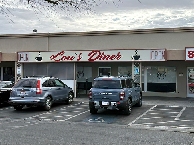 Lou's Diner's unassuming strip mall exterior is like finding a treasure chest disguised as a shoebox&mdash;the red script promising delicious secrets within.