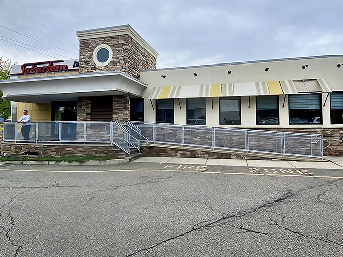 The stone facade and welcoming entrance of Suburban Diner stands as a beacon of comfort food promise along Paramus's busy commercial corridor.