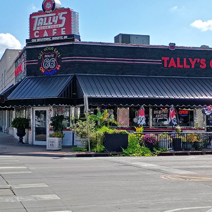 The neon-lit promise of Route 66 nostalgia beckons hungry travelers. Tally's exterior is like a time machine disguised as a diner.