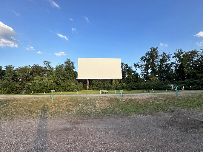 The blank canvas awaits as afternoon fades to evening. Cinema's most democratic venue stands ready for its nightly transformation.