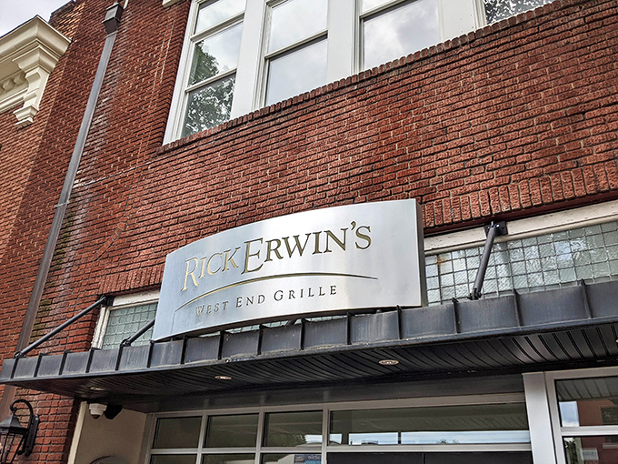 The iconic brick fa&ccedil;ade of Rick Erwin's West End Grille&mdash;where Greenville's culinary dreams come true beneath that elegant silver signage.