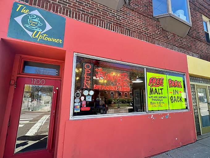 The bright red facade of The Uptowner beckons like a breakfast lighthouse on Grand Avenue, complete with vintage neon promising morning salvation.