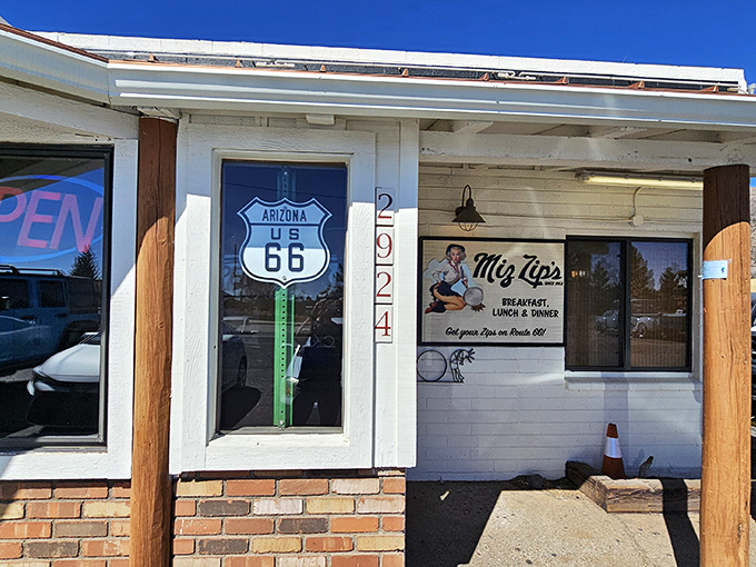 The classic Route 66 sign beckons hungry travelers to Miz Zip's, where time slows down and appetites perk up. A roadside promise of comfort since 1952.