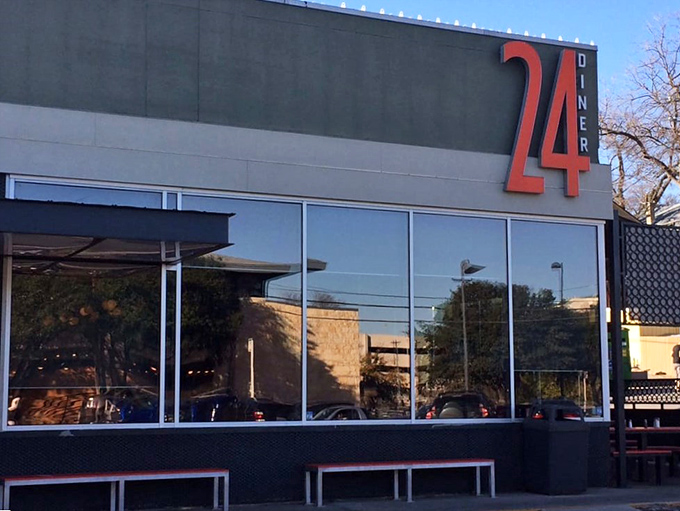 The exterior's sleek design whispers "modern" while the orange umbrellas shout "come on in, we're fun!"