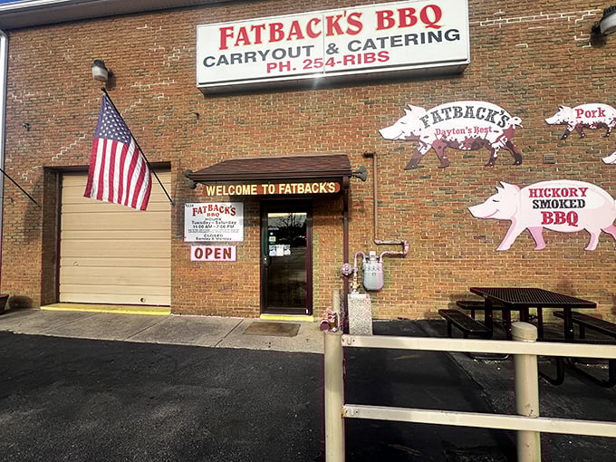 The brick exterior of Fatback's BBQ welcomes hungry visitors with playful pig silhouettes and an American flag&mdash;a carnivore's embassy on Dayton soil.