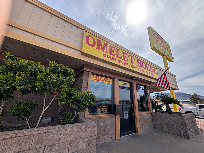 The unassuming yellow sign of Omelet House beckons like a breakfast lighthouse, promising eggy treasures within these Henderson walls.