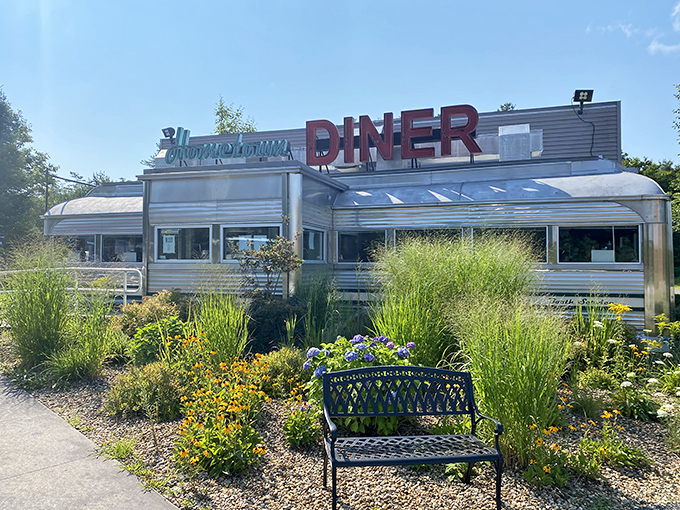 The gleaming chrome exterior of Hometown Diner shines like a beacon of hope for hungry travelers passing through Rindge, New Hampshire.