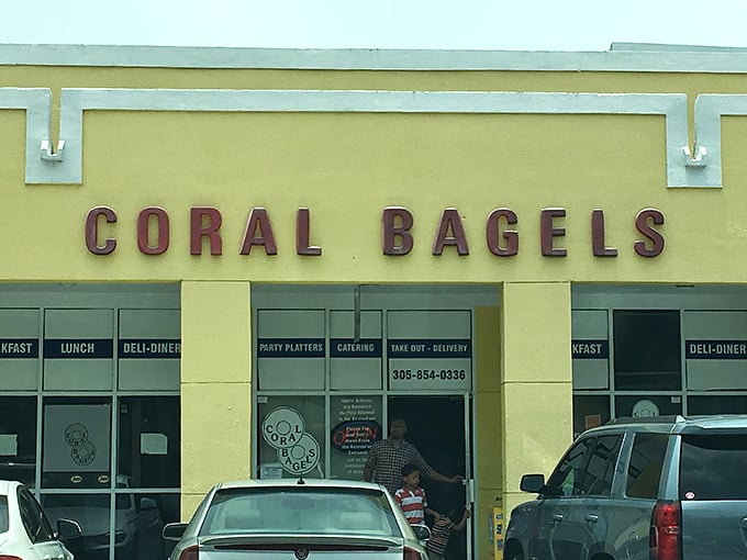 The unassuming yellow facade of Coral Bagels stands as Miami's breakfast bat-signal, beckoning hungry locals with promises of comfort food glory.
