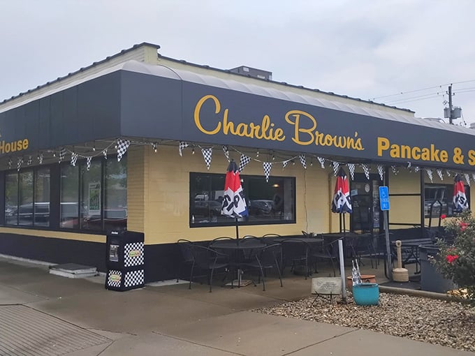 The bright yellow exterior of Charlie Browns stands like a beacon of breakfast hope on Speedway's Main Street, promising pancake paradise within.