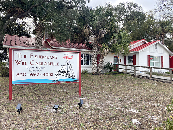 The unassuming white cottage with red trim might not scream "culinary destination," but locals know this Carrabelle treasure holds seafood secrets worth discovering.