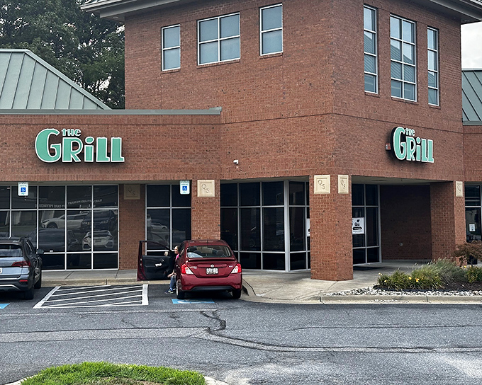 The unassuming brick exterior hides culinary treasures like a food speakeasy. Those green signs might as well say "Deliciousness Ahead."