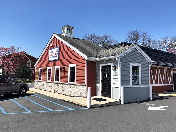 Morning sunshine highlights the charming barn-inspired architecture, complete with cupola and nautical flags that whisper promises of seafood treasures within.