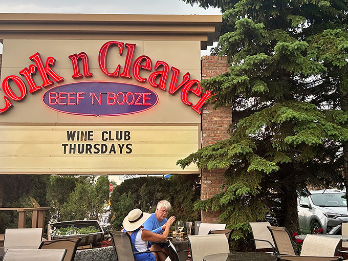 The neon glow of "BEEF 'N BOOZE" isn't just signage&mdash;it's a promise. Cork 'N' Cleaver's exterior beckons carnivores with refreshing honesty about its priorities.