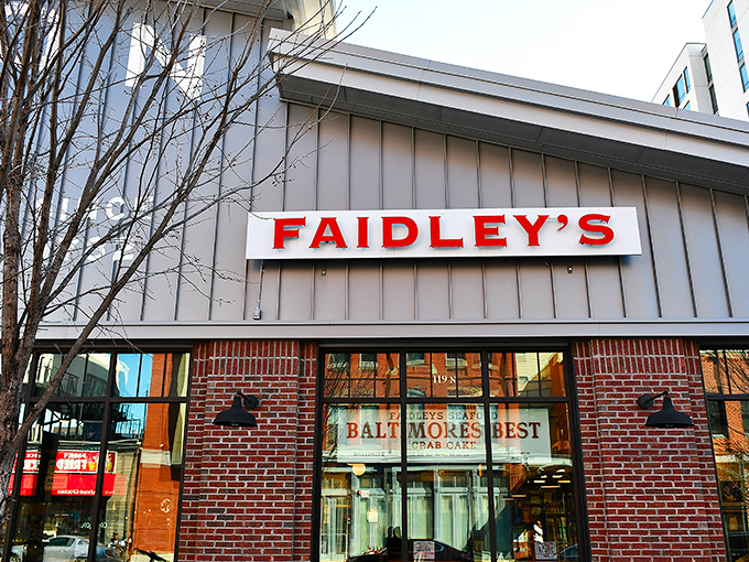 The red letters of Faidley's sign stand out like a beacon for seafood pilgrims. This unassuming exterior houses Baltimore's most sacred crab cake sanctuary.