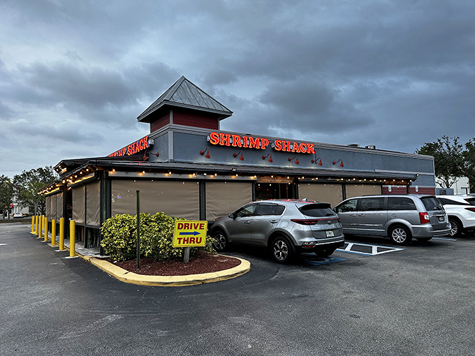 A glimpse of seafood paradise from the outside &ndash; where the neon "Shrimp Shack" sign serves as a beacon to hungry travelers like a lighthouse guiding ships home.