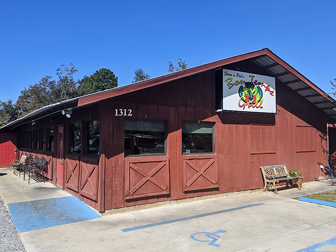 The rustic red exterior of Bon Temps Grill beckons like a culinary lighthouse in Lafayette, promising authentic Cajun flavors behind those barn-style doors.
